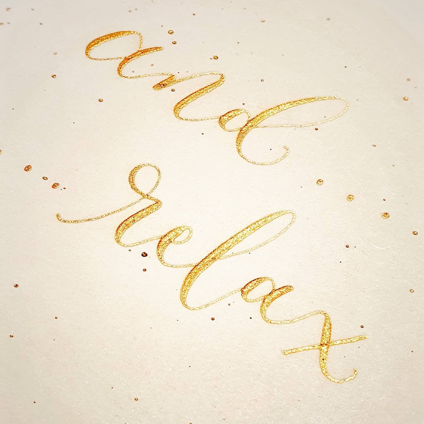 handwritten calligraphy saying and relax in gold